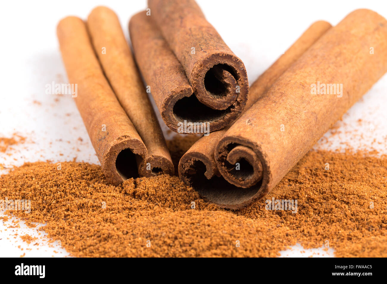 cinnamon sticks with powder isolated on white background Stock Photo ...