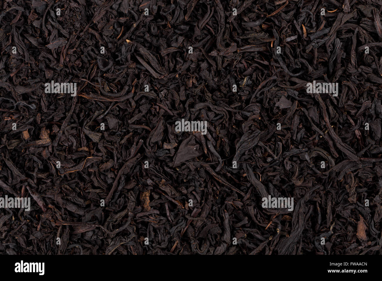 dry black tea leaves close up of texture for background Stock Photo - Alamy