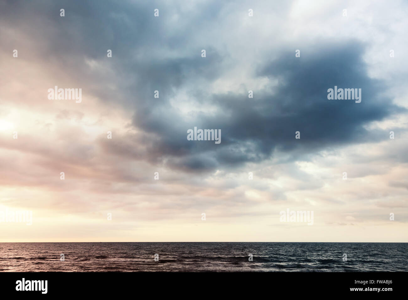 Colorful dramatic sky with clouds over sea water at sunrise Stock Photo ...