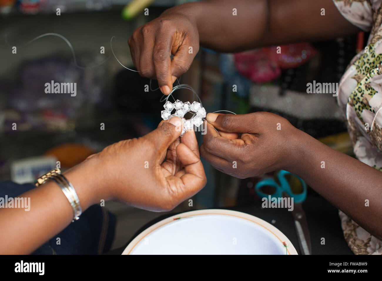Two women making beaded decorations in Nigeria, Africa Stock Photo - Alamy