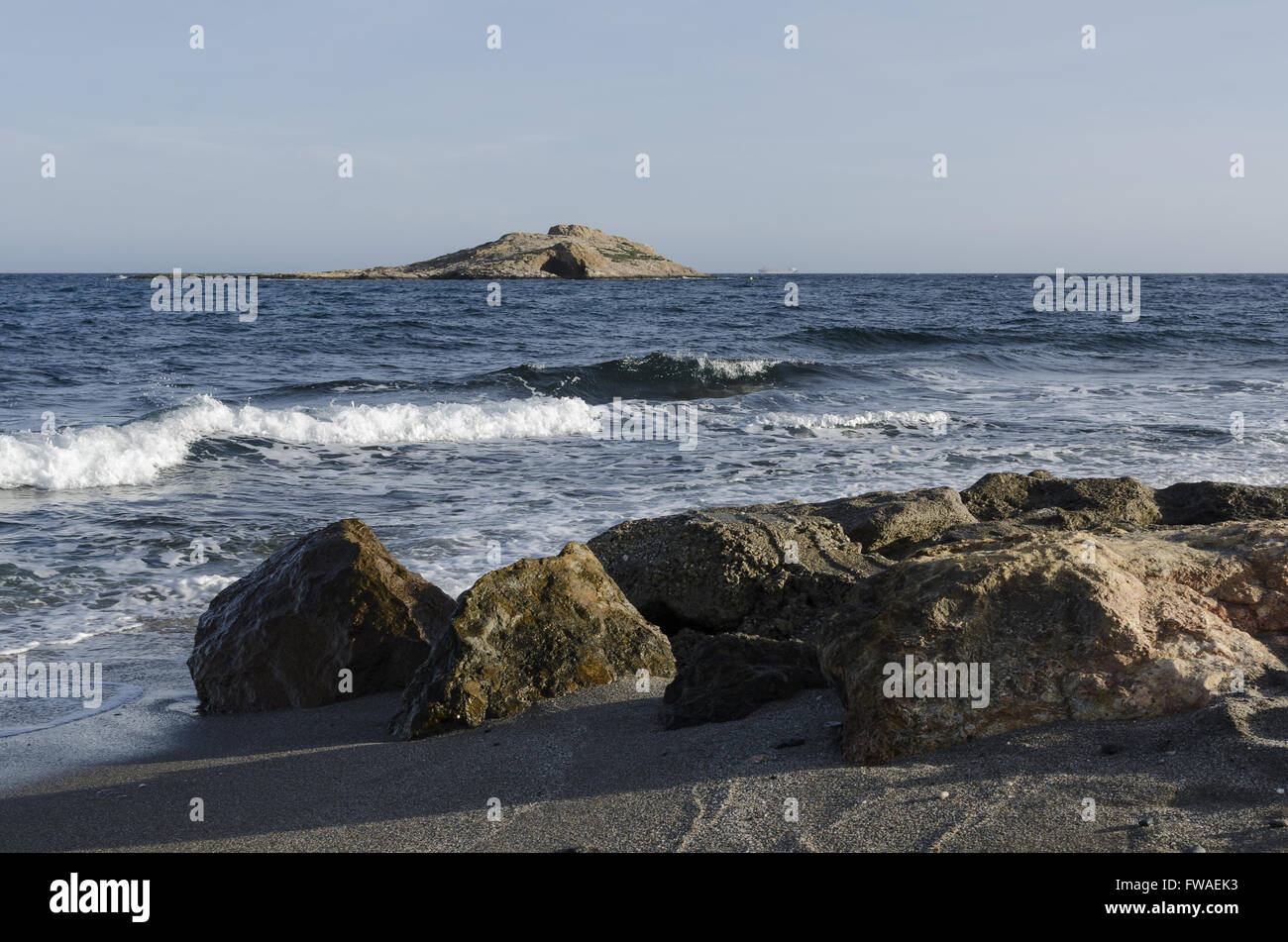 Some rocks and island view in Carboneras beach, Almeria province, Spain ...