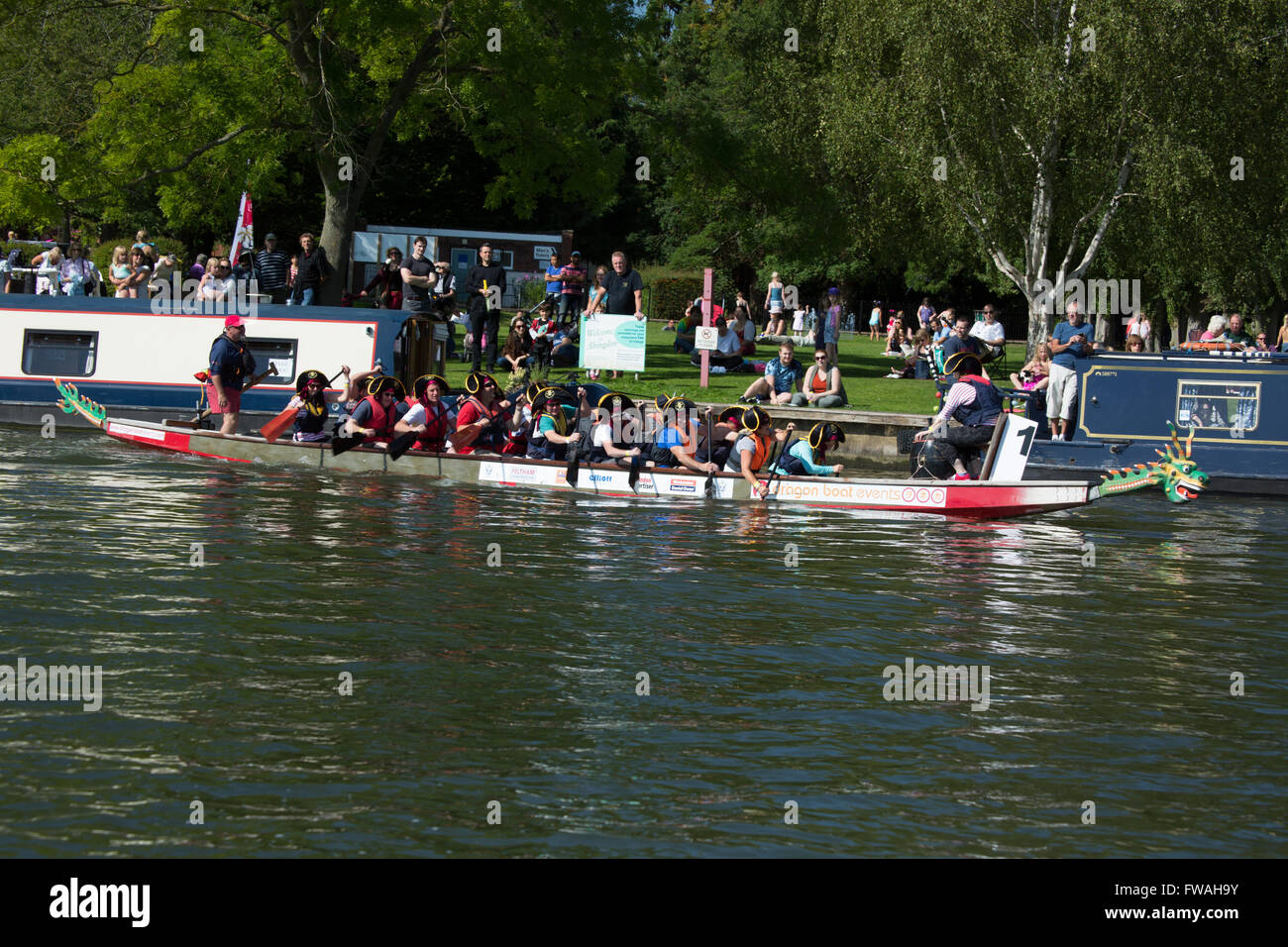 Dragon Boat crew paddles to the start of the race Stock Photo - Alamy
