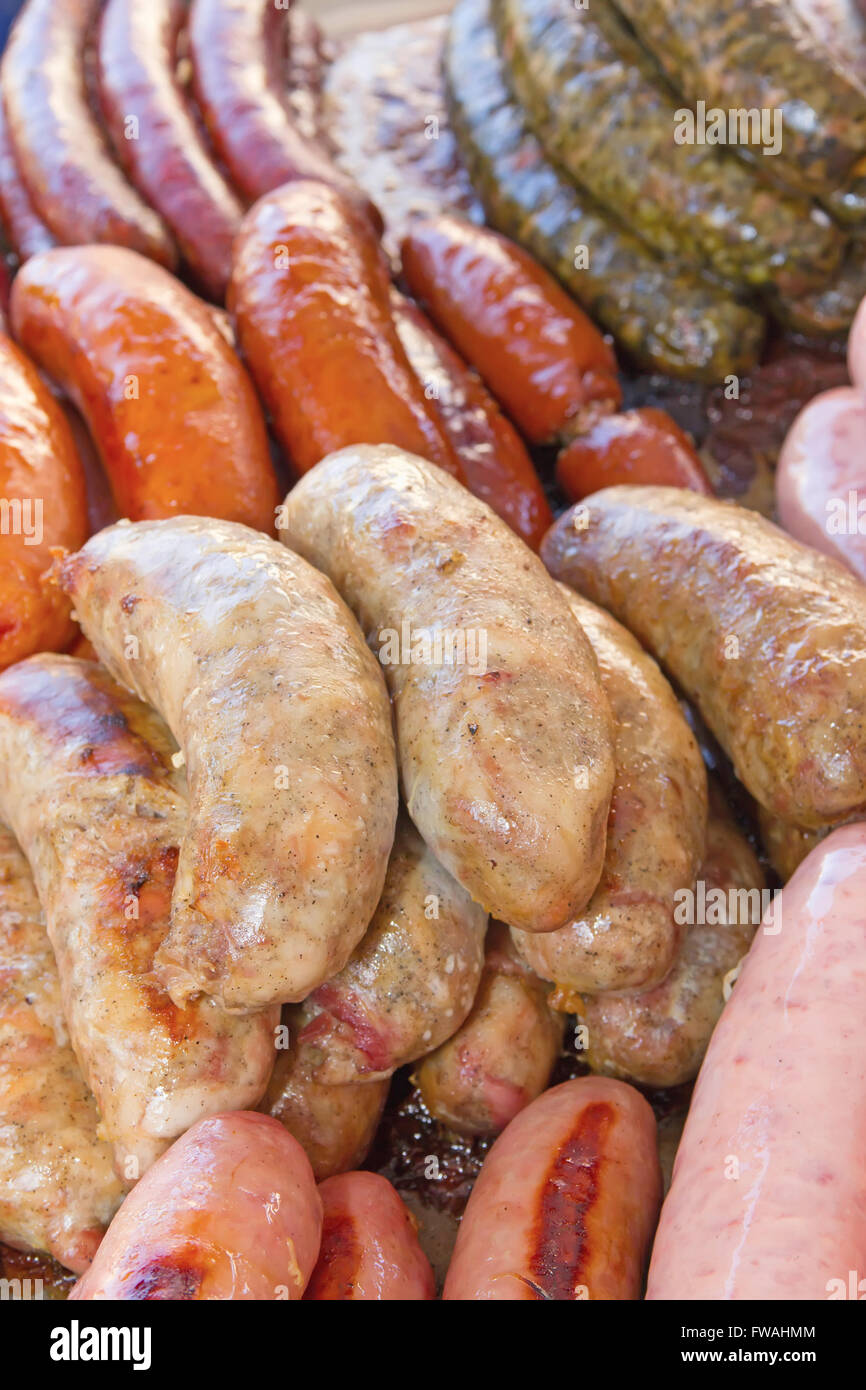 Assorted grilled types of sausages ready for sale at a farmer's market ...