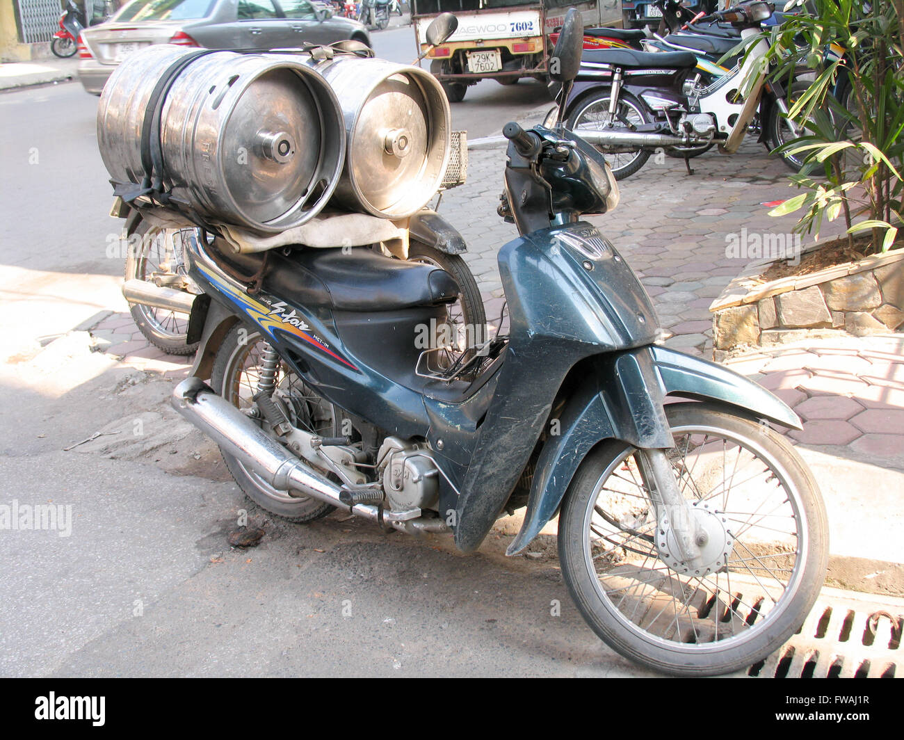 A motorbike with two beer kegs attached to it Stock Photo - Alamy