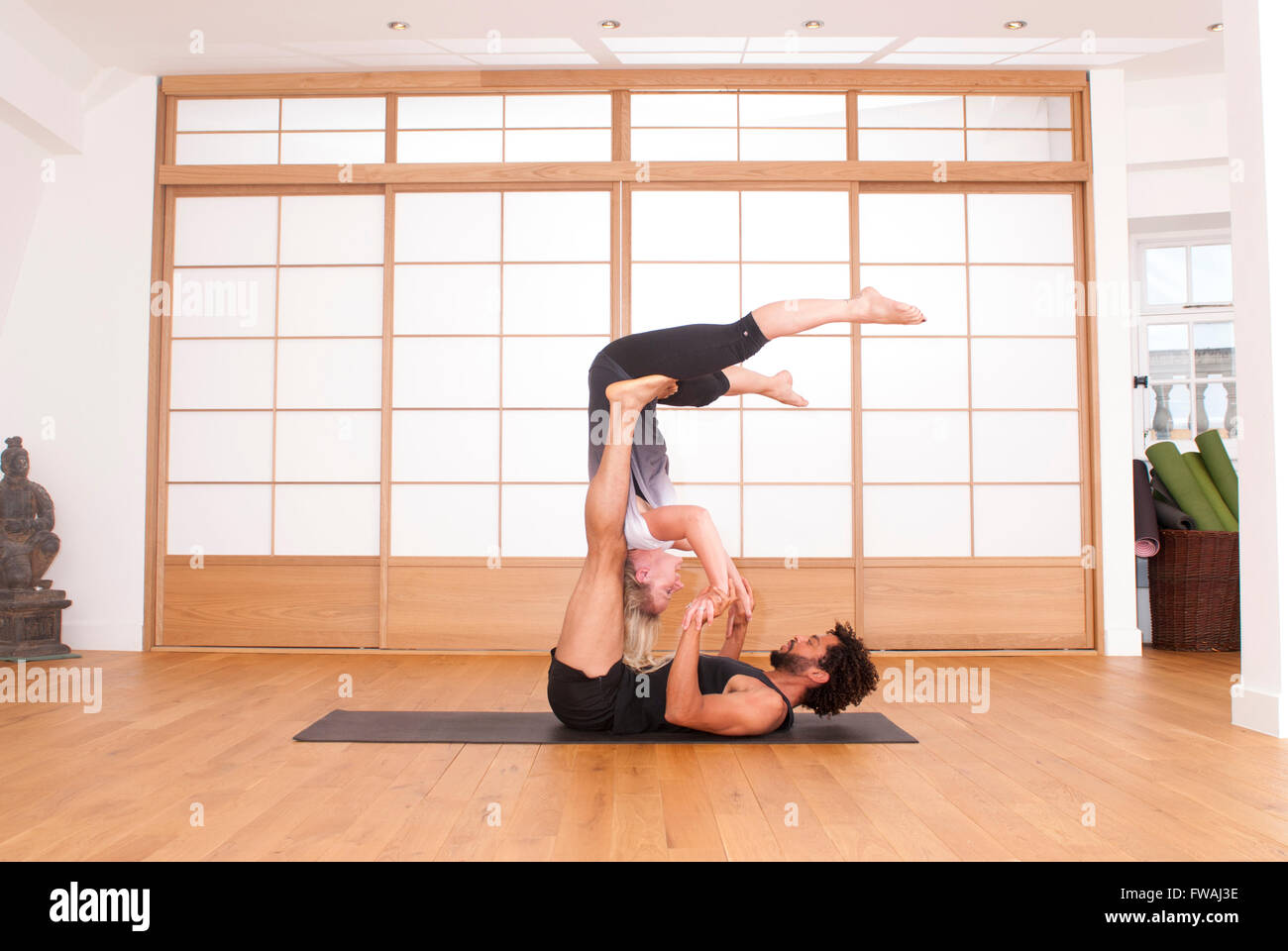Acro Yoga teaching through demonstration Stock Photo - Alamy