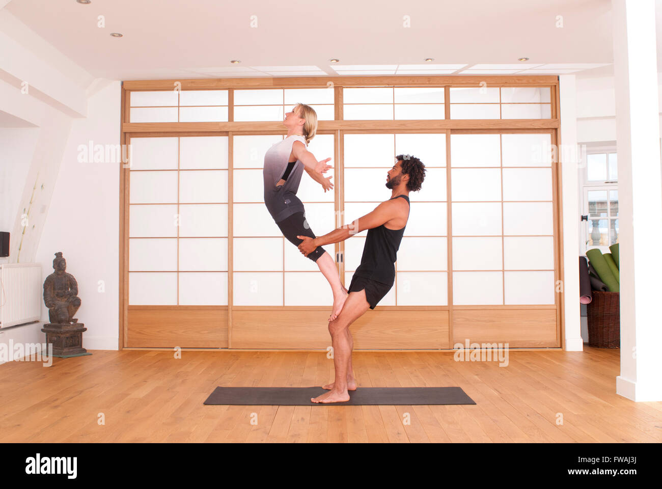 Acro Yoga teaching through demonstration Stock Photo - Alamy
