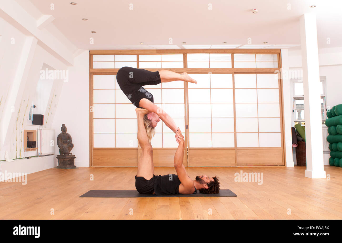 Acro Yoga teaching through demonstration Stock Photo - Alamy