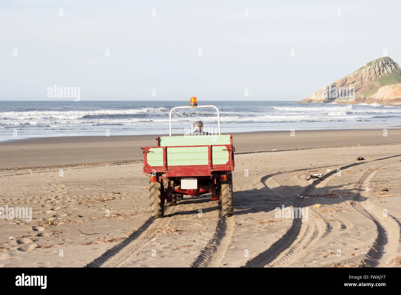 Rear view of a tractor at beach Stock Photo - Alamy