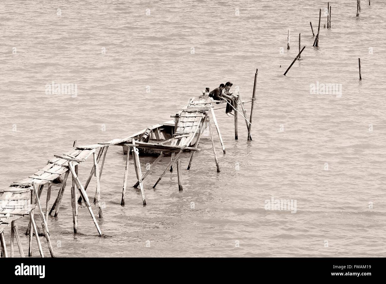 ALAT, AZERBAIJAN - APRIL 14 2014 Boys fishing in Caspian Sea on broken ...