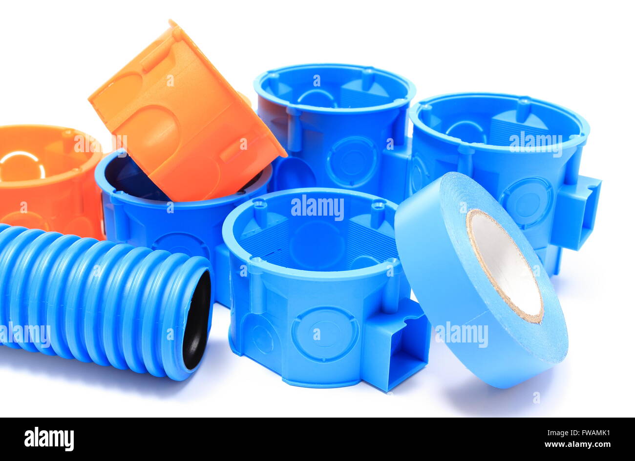 Heap of blue and orange electrical boxes with components for use in ...