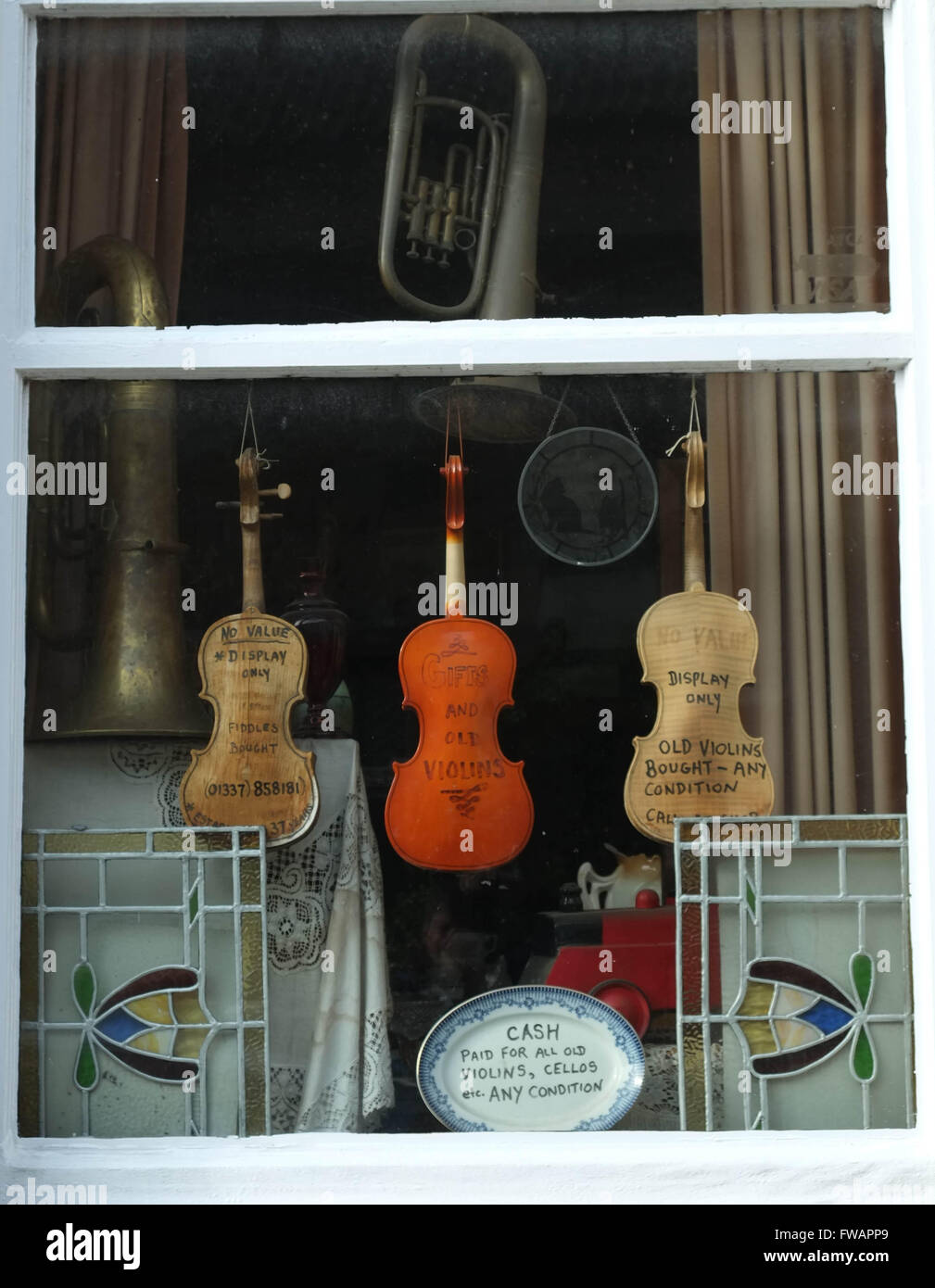 03/04/2016, Violins hang in a shop window in the village of Falkland ...