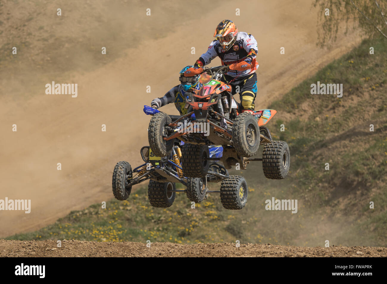 Two quad riders are jumping over the horizon in the quad race Stock ...