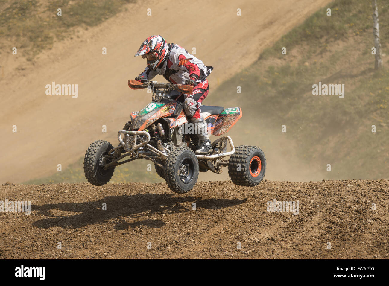 Racer is jumping a quad bike in the race Stock Photo - Alamy