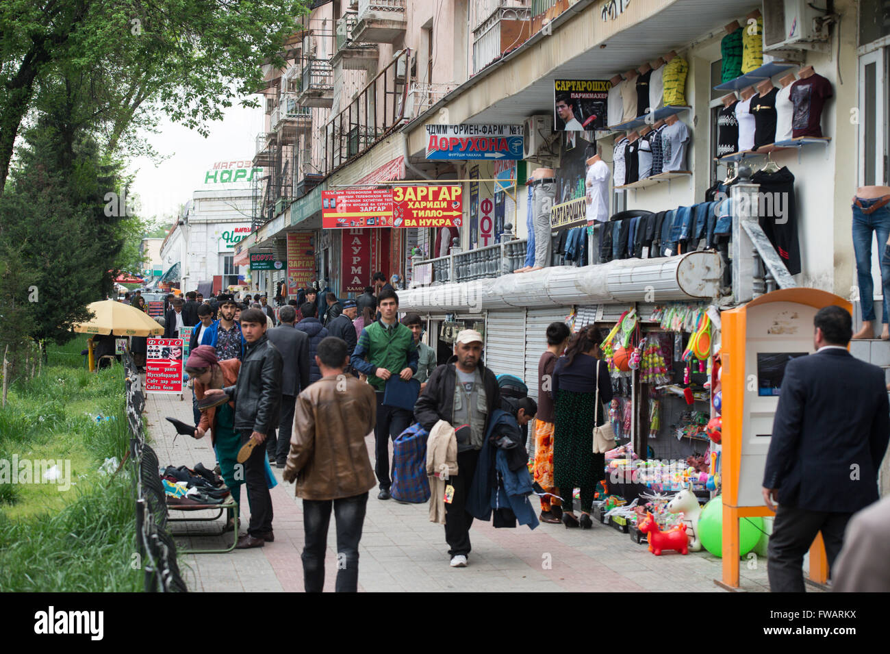 Dushanbe, Tajikistan. 01st Apr, 2016. Pedestrians walk past clothing ...