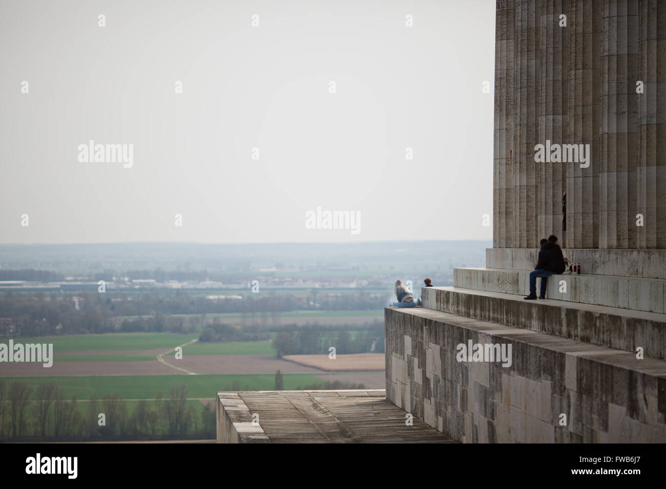 Tourists sitting in the sun on the walls of the Walhalla memorial site ...