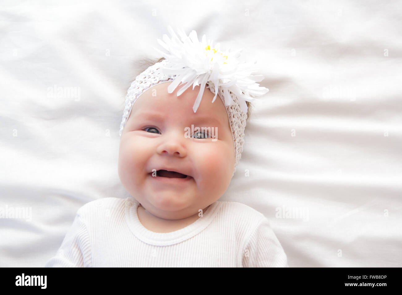 Little newborn girl lying on the bed Stock Photo - Alamy