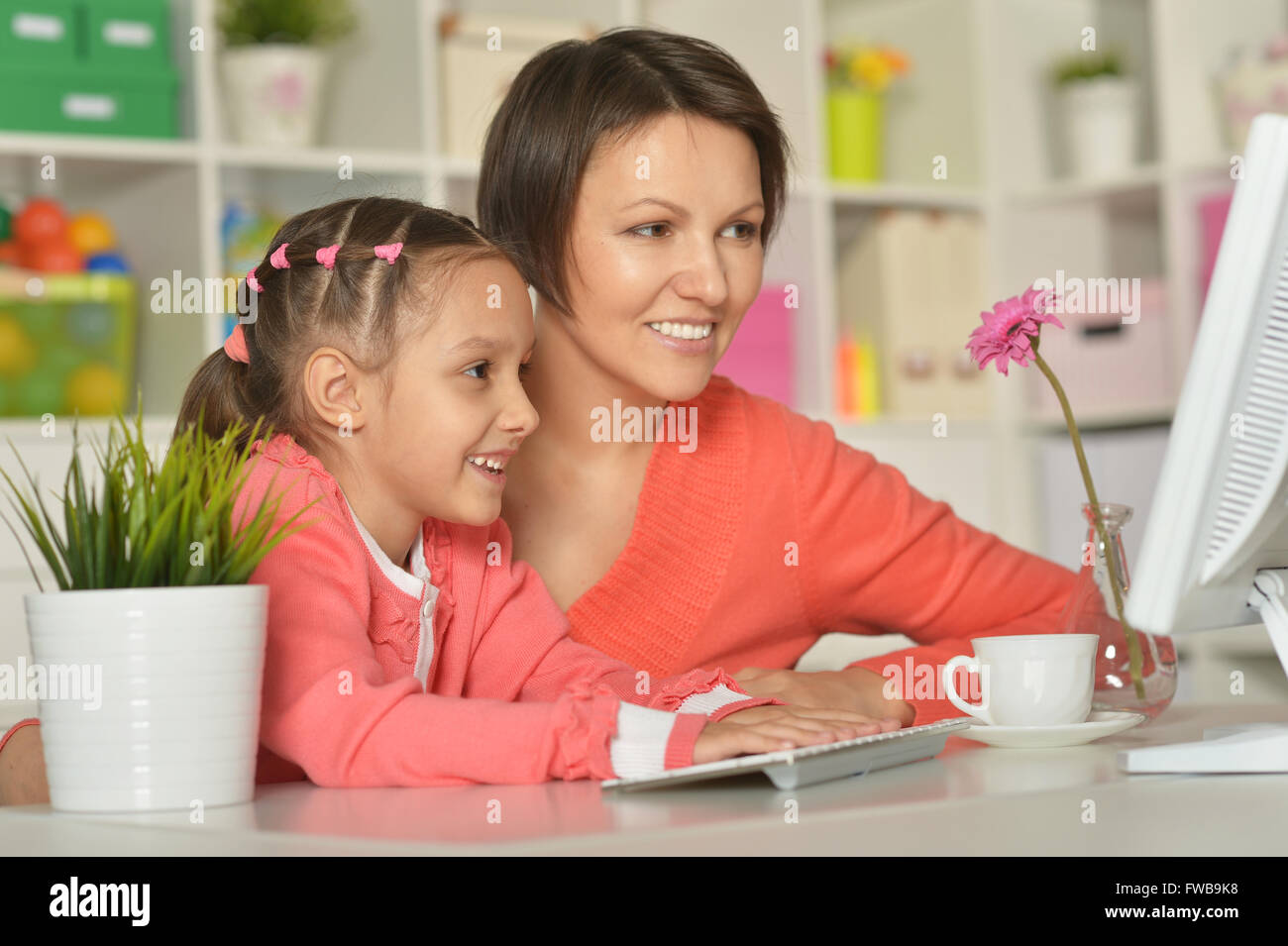 little girl with mother and computer Stock Photo - Alamy