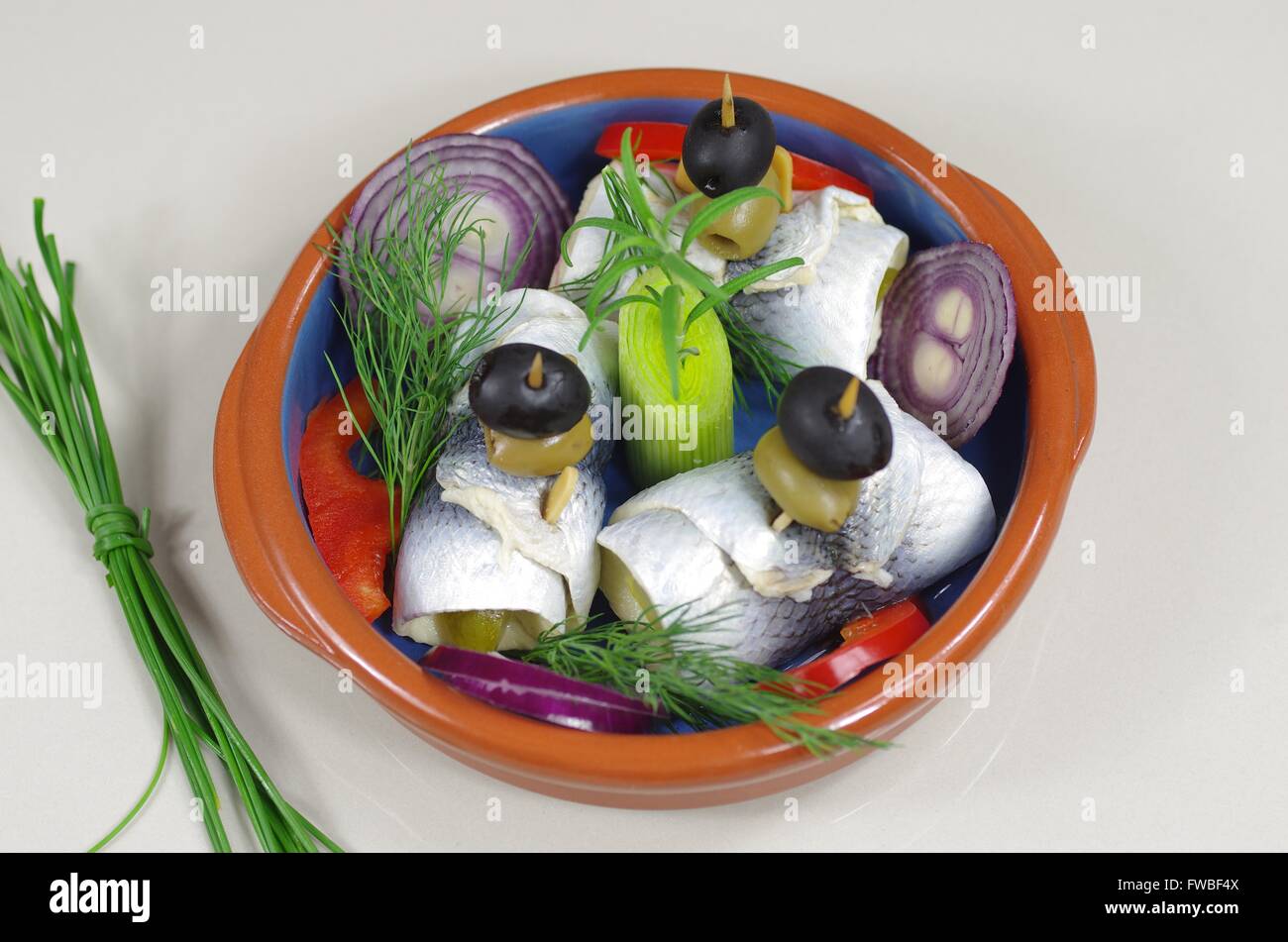 appetizing rollmop with onion and dill Stock Photo - Alamy