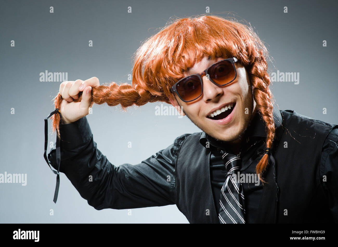 Funny man with red hair wig Stock Photo - Alamy