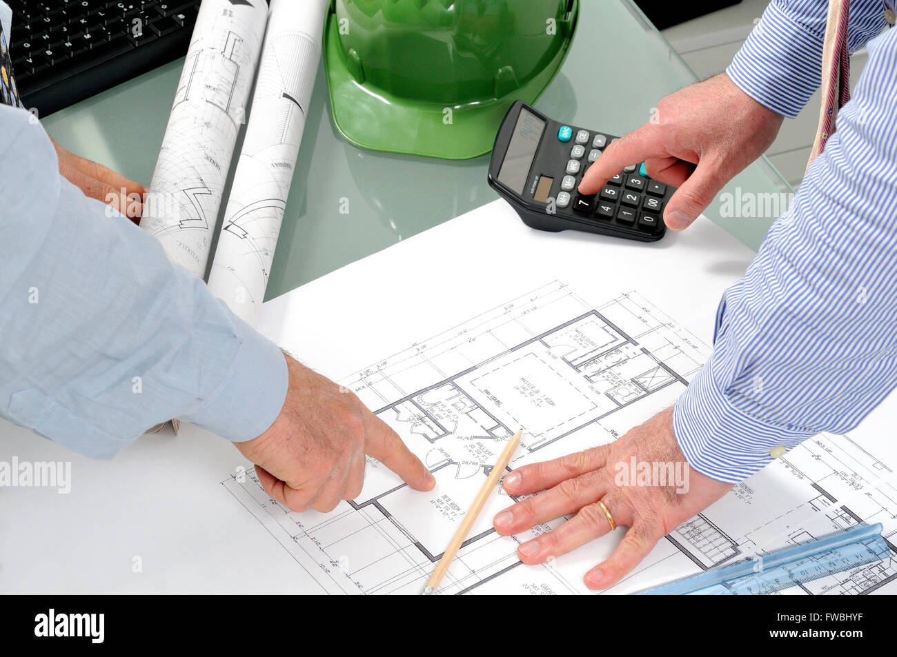 Architects at work in the office on a residential construction project ...