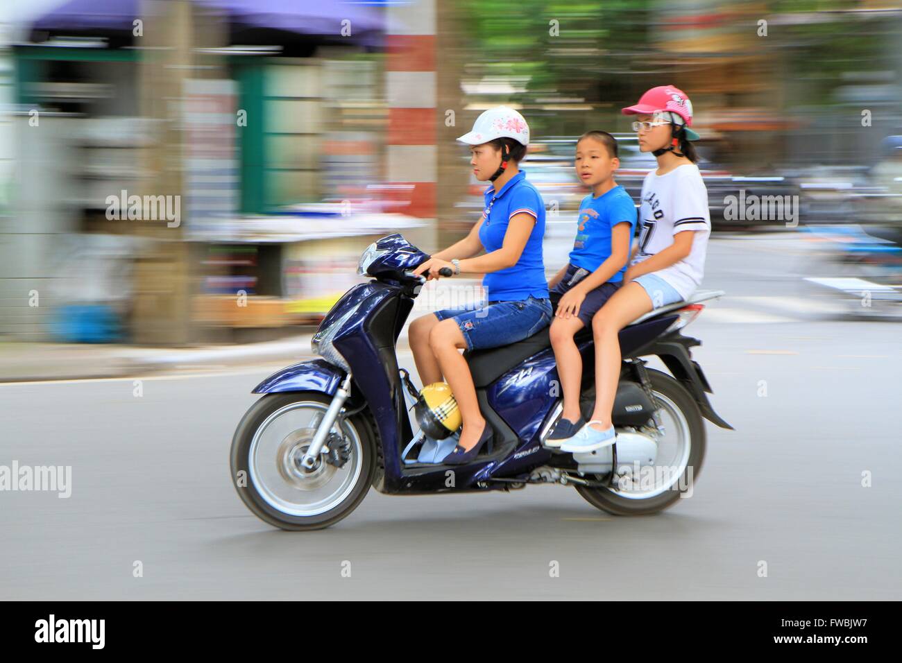Vietnamese family riding a motorbike in Hanoi, Vietnam, Asia Stock ...