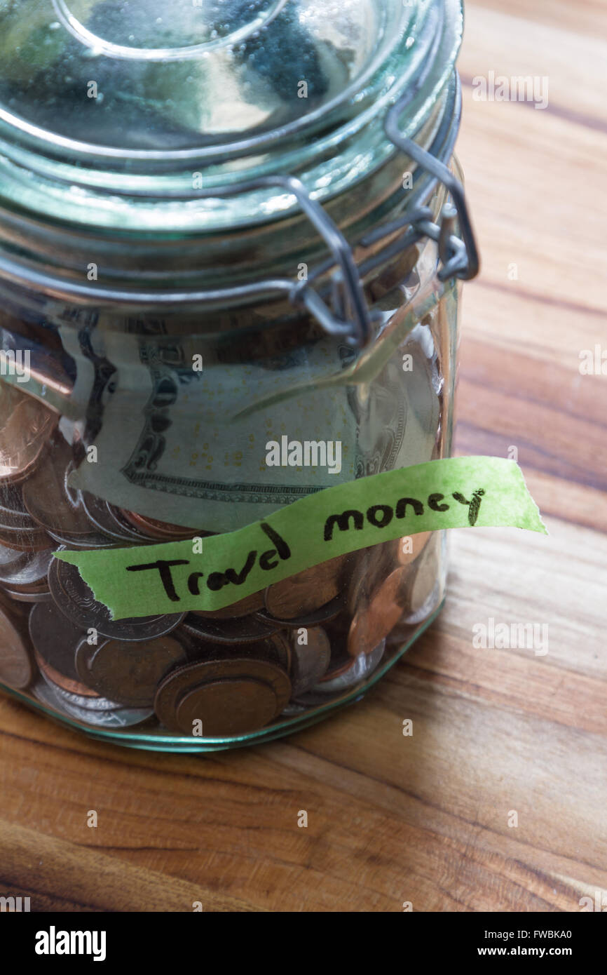 close up of a jar with money and a label using green tape and a black ...