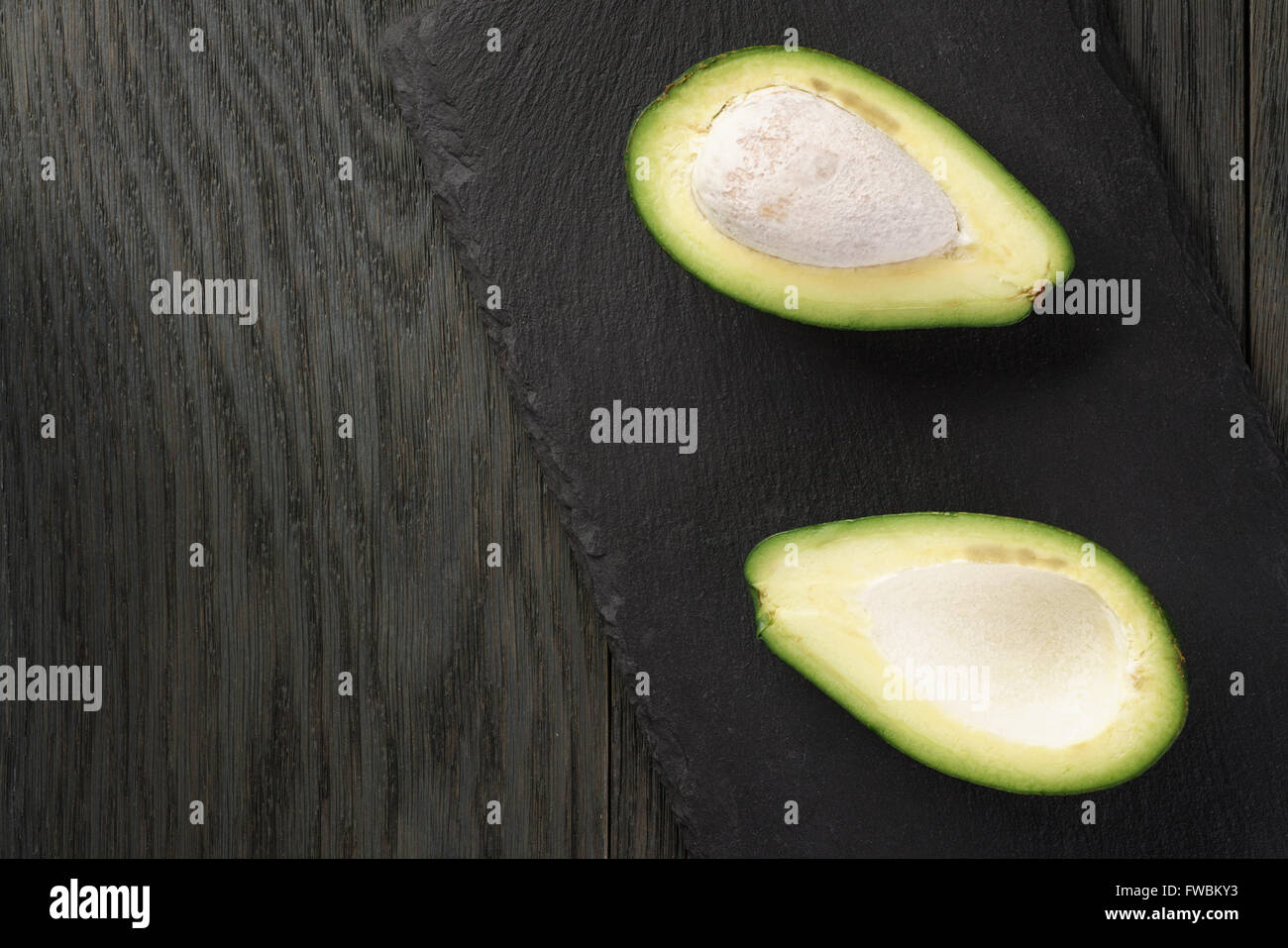 ripe green avocados on wood table Stock Photo - Alamy