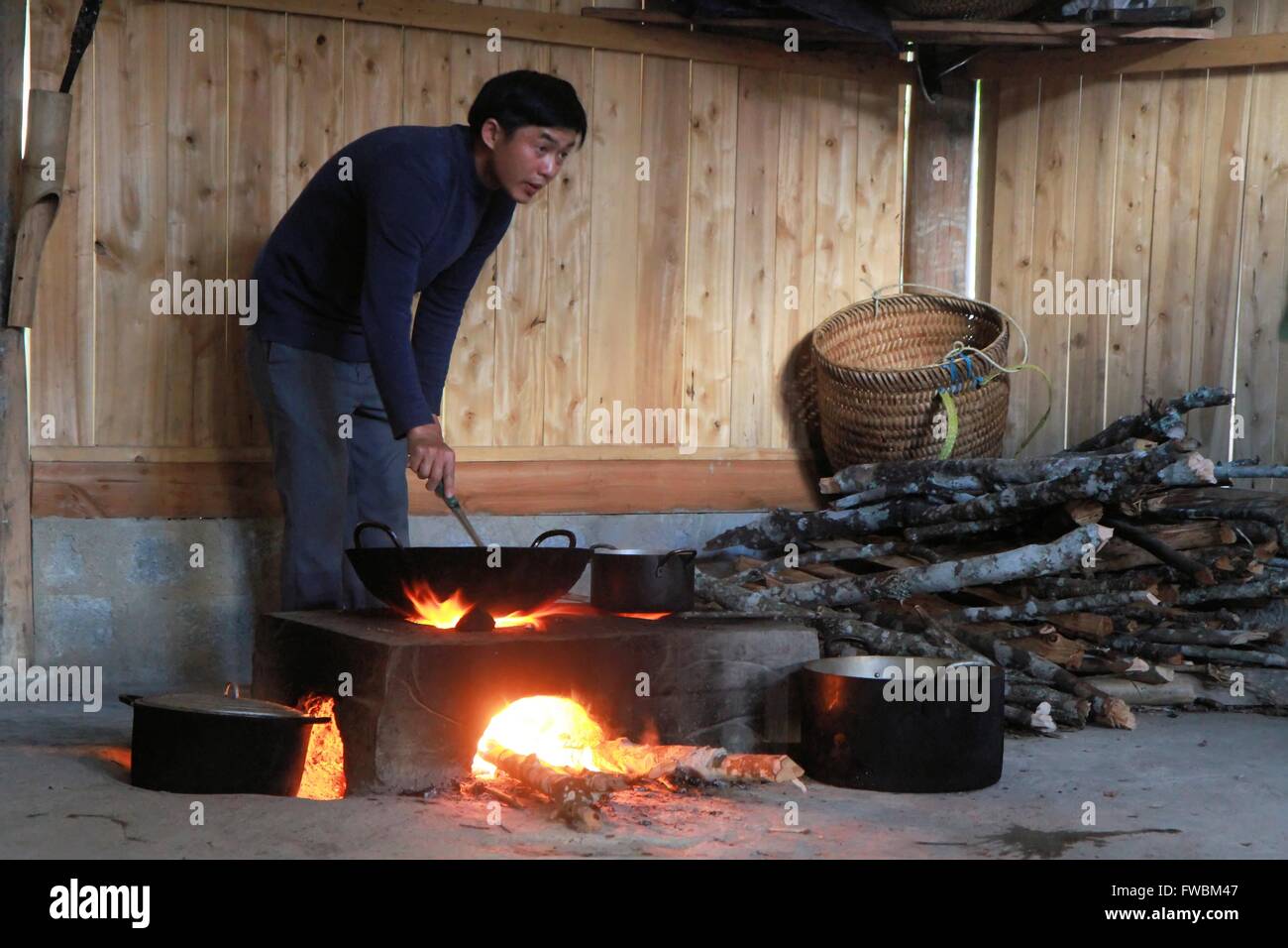 Hill-tribe man cooking meal Stock Photo - Alamy