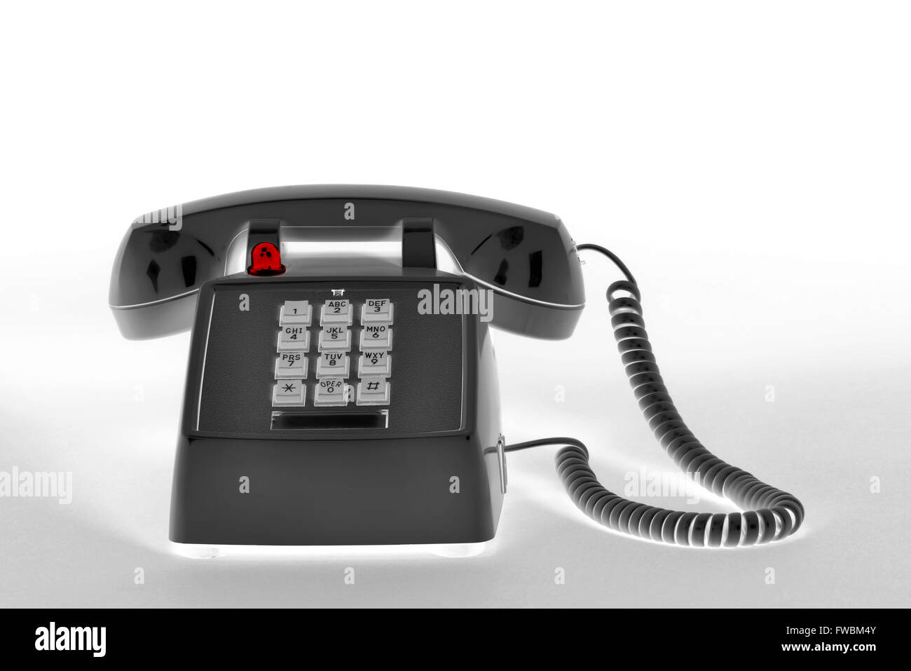 Old style telephone in reversed black and white Stock Photo - Alamy
