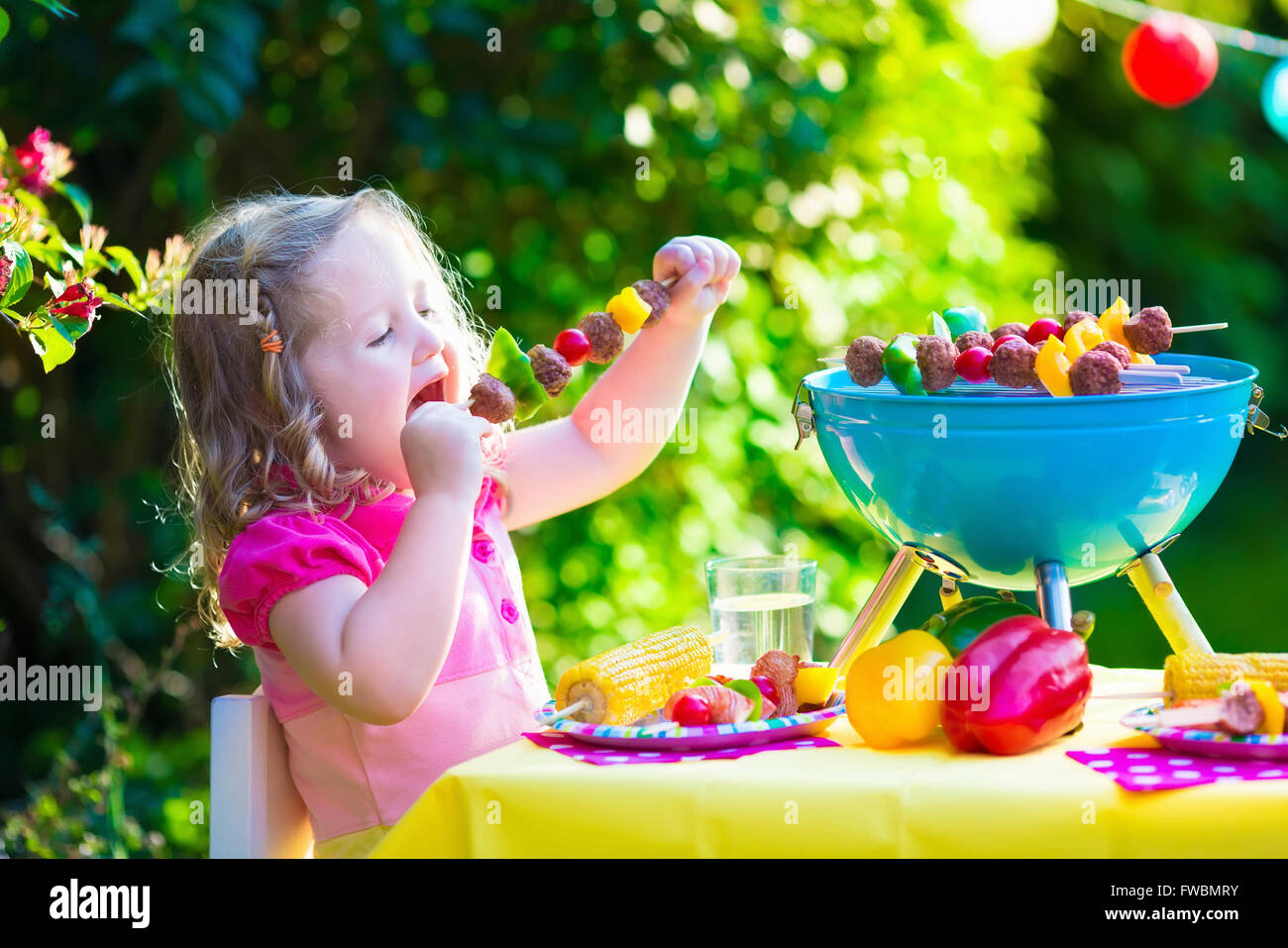 Children grilling meat. Family camping and enjoying BBQ. Little girl at ...