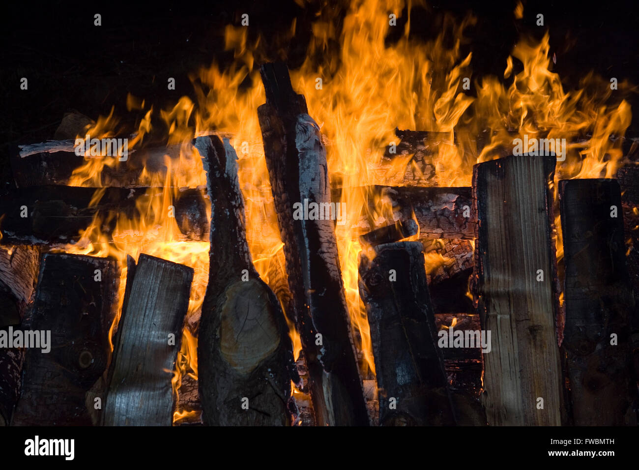 Logs, wood burning on what could be described as a funeral pyre in some ...