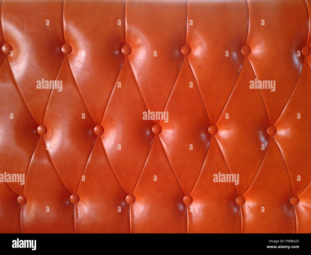 Orange color leather chair upholstered seat. Pinned with pins Stock ...