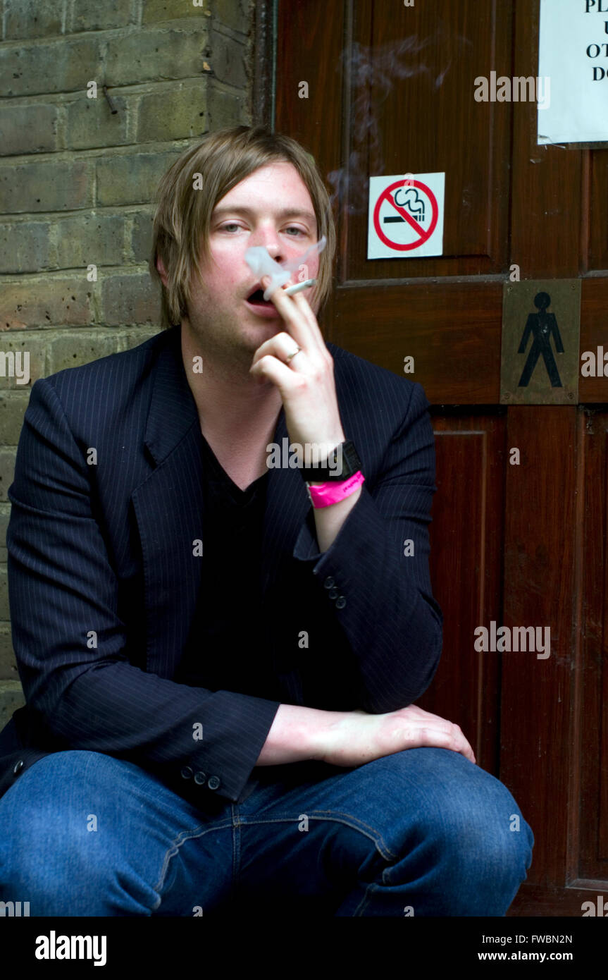 Portrait of writer Stuart Evers smoking a cigarette. Stuart's books ...