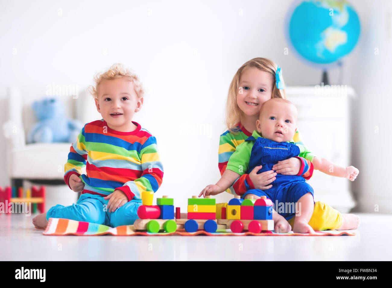 Children playing with wooden train. Toddler kid and baby play with ...