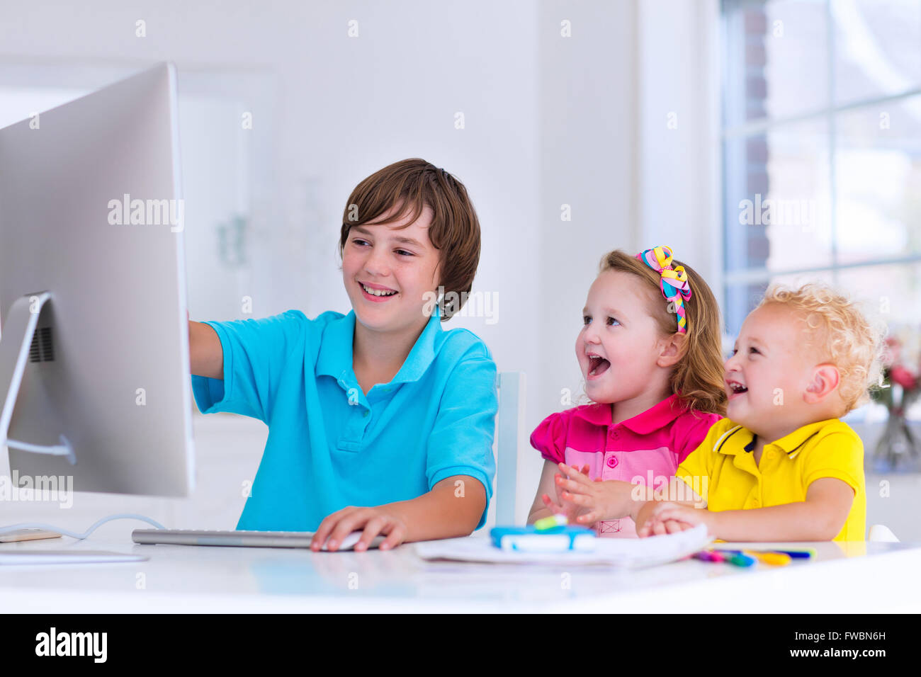 School kids working on personal computer at home. Student doing ...