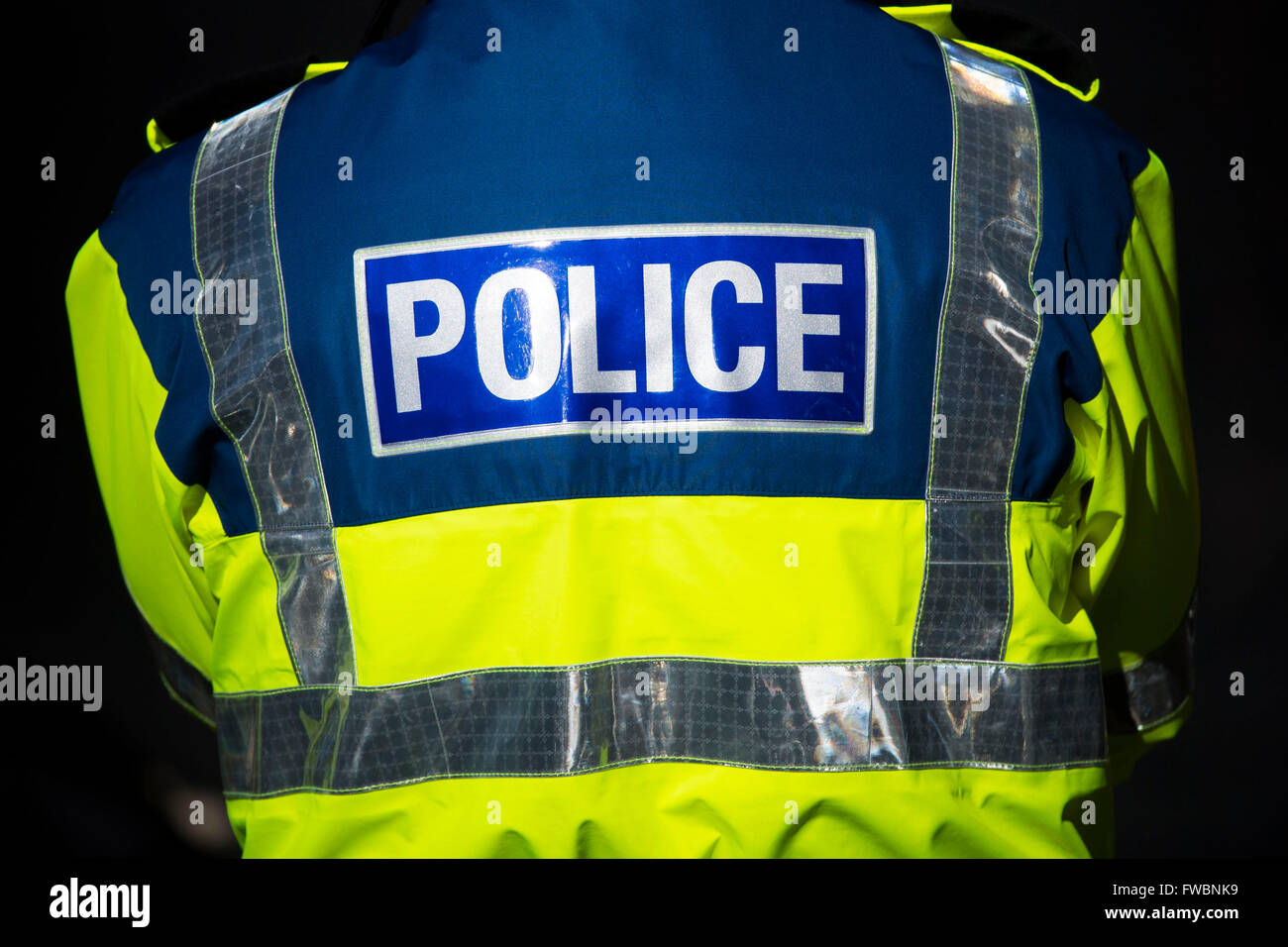 Police officer seen from behind showing sign logo Stock Photo - Alamy