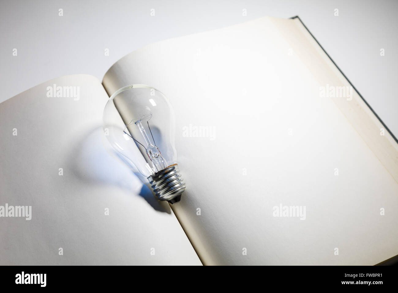 book and light bulb, business education concept Stock Photo - Alamy