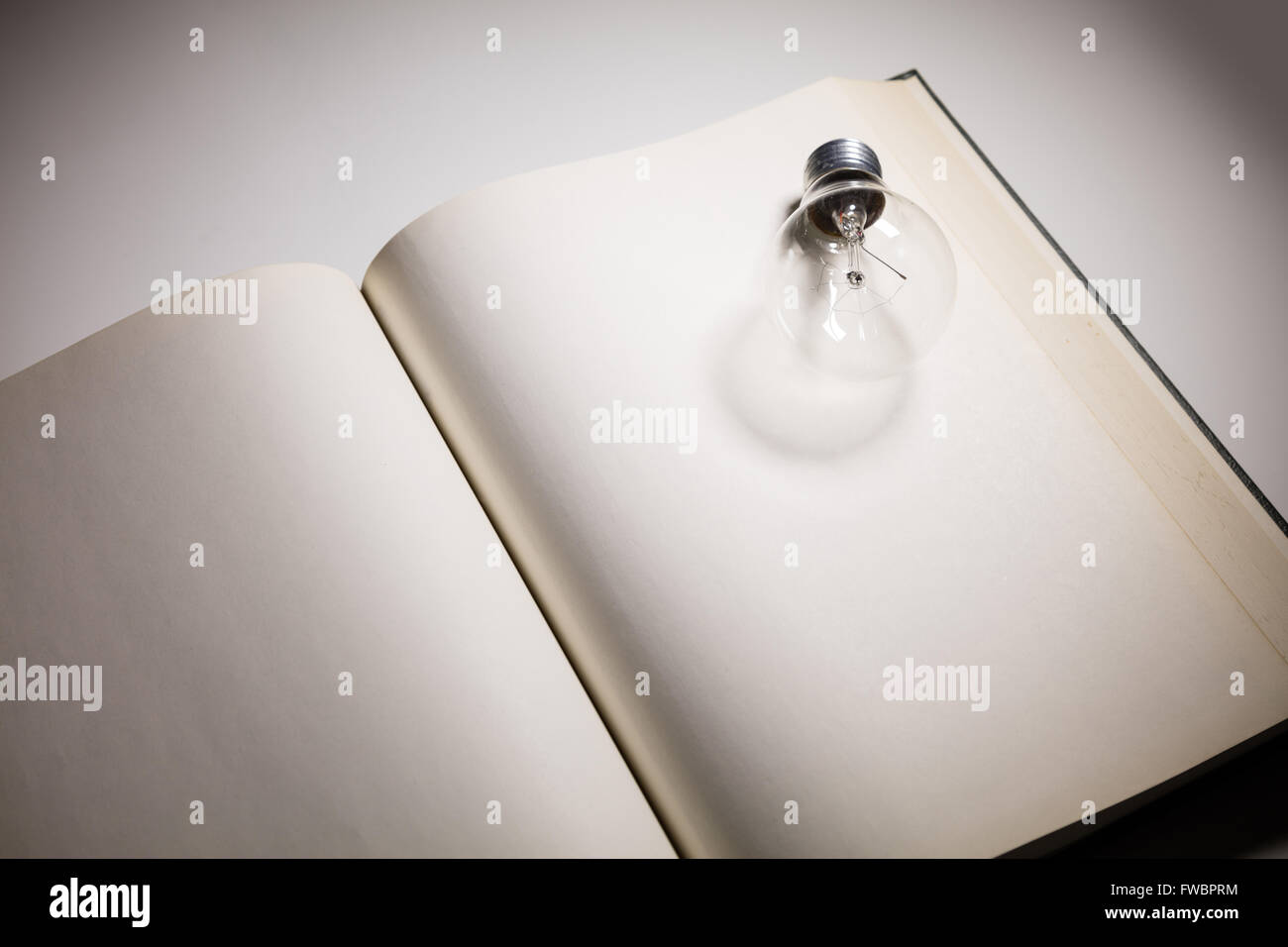 book and light bulb, business education concept Stock Photo - Alamy