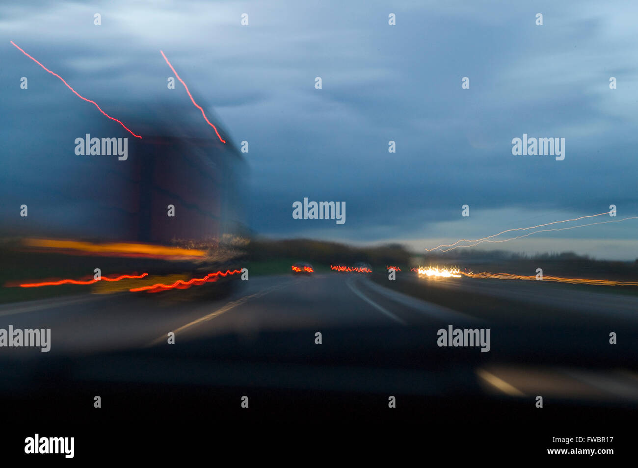 The view through a car window as it overtakes a lorry or truck at speed ...