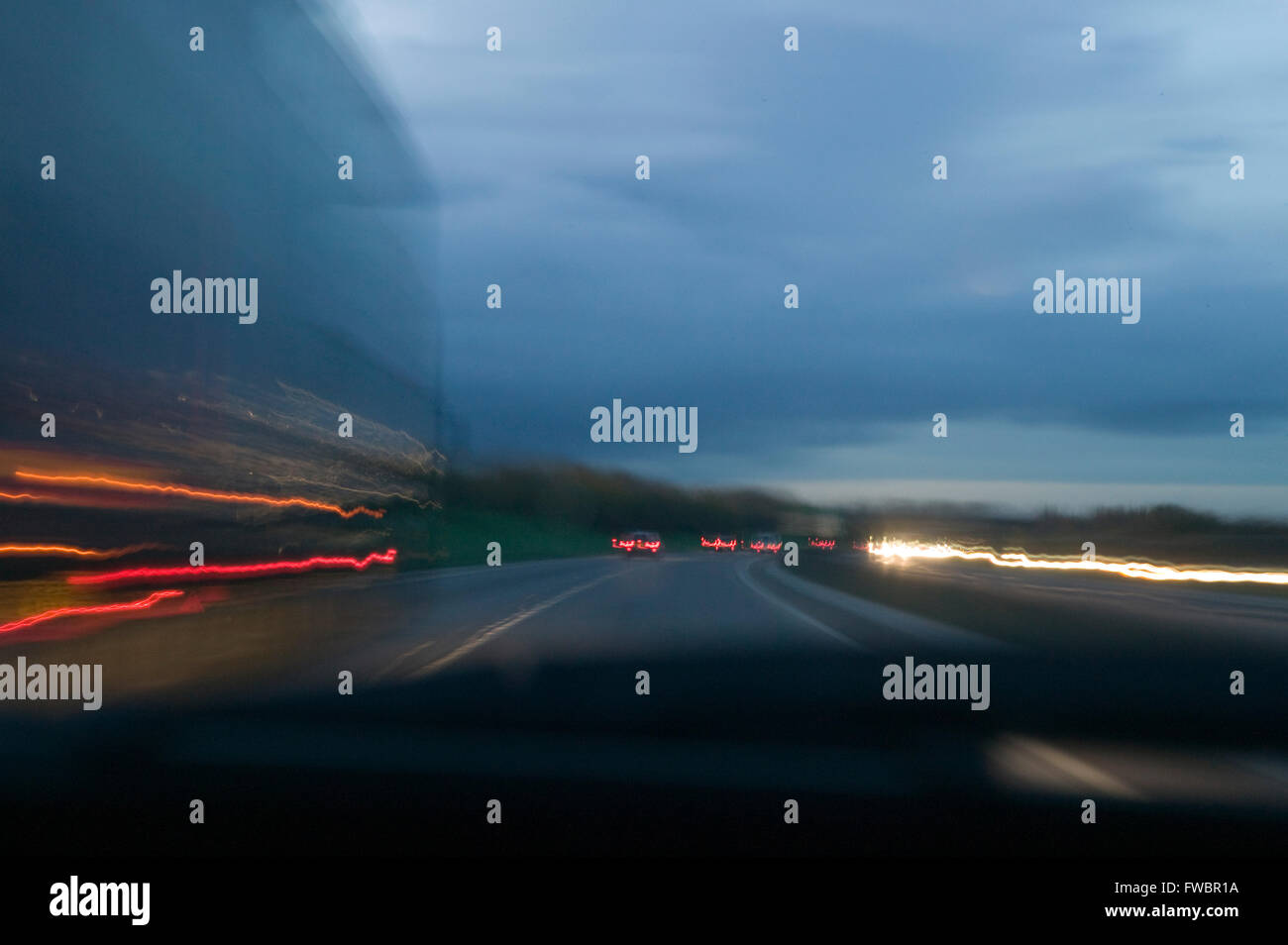 The view through a car window as it overtakes a lorry or truck at speed ...