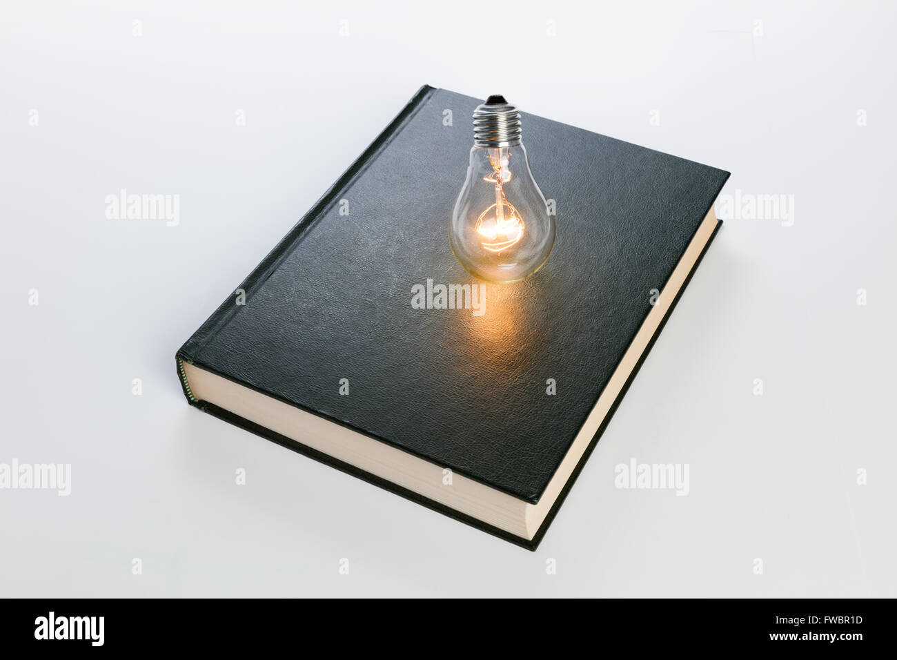 book and light bulb, business education concept Stock Photo - Alamy