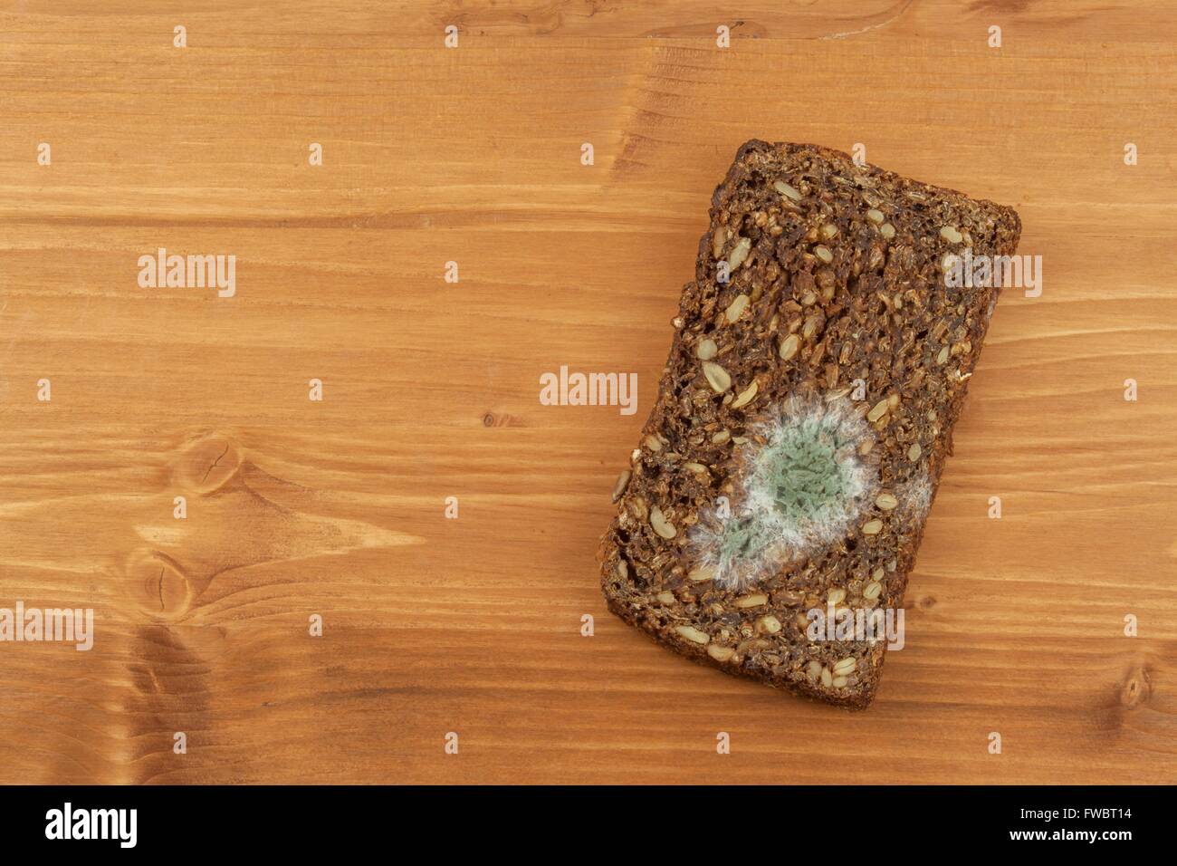 Moldy bread in wooden table. Unhealthy food. Spoiled food Stock Photo ...