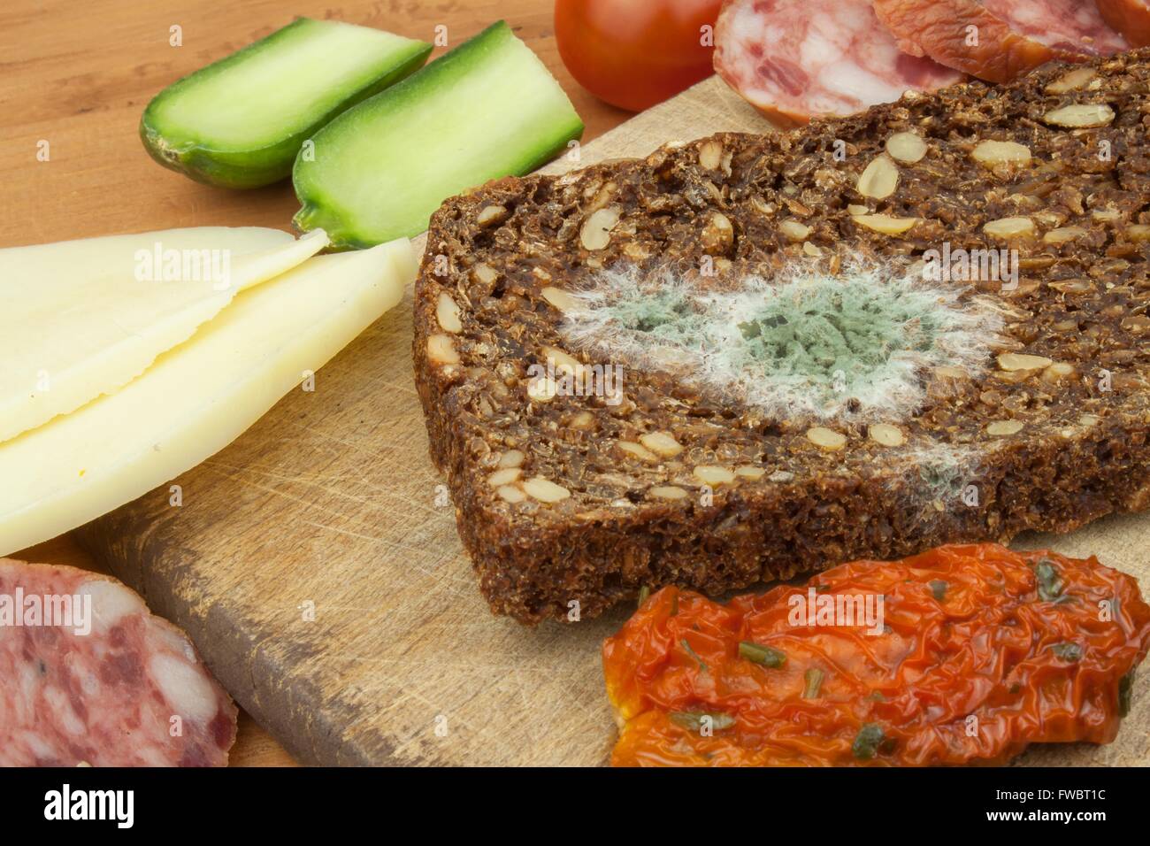 Moldy bread in wooden table. Unhealthy food. Spoiled food Stock Photo ...