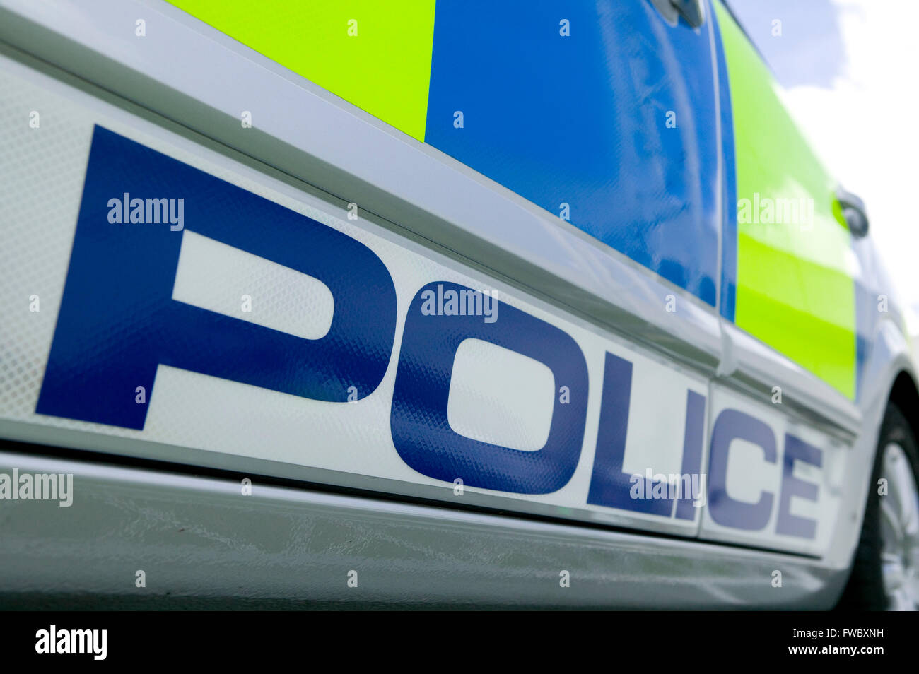 The side of a police car showing the large lettering and the relfective ...