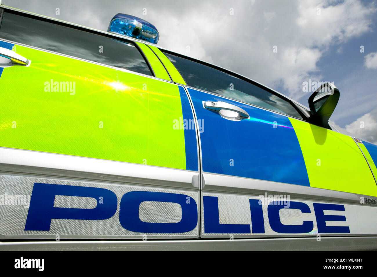 The side of a police car showing the large lettering and the relfective ...