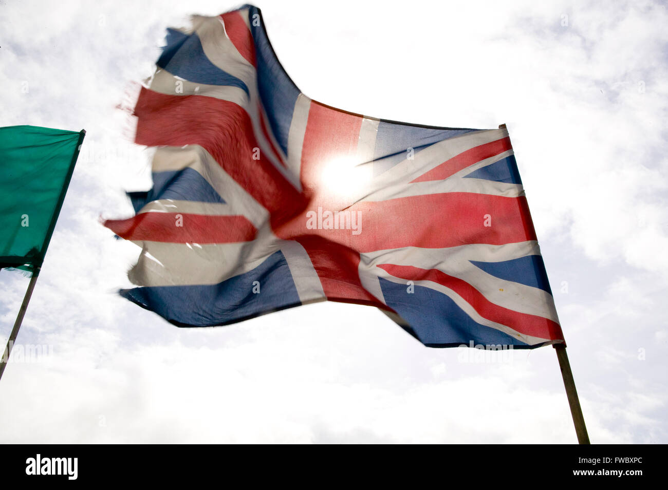 Ripped and worn union jack flag in the breeze Stock Photo - Alamy