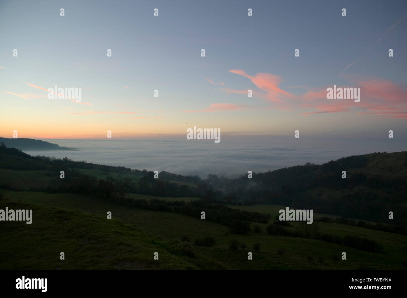 The view across a valley in the Cotswolds, Gloucestershire, UK as the ...