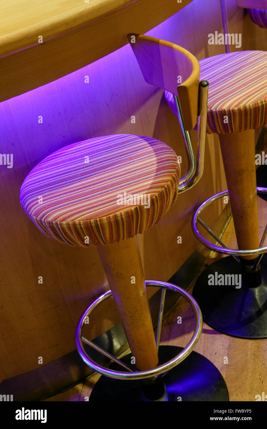 Stylish bar stools standing empty at a bar in a restaurant or acfe in ...