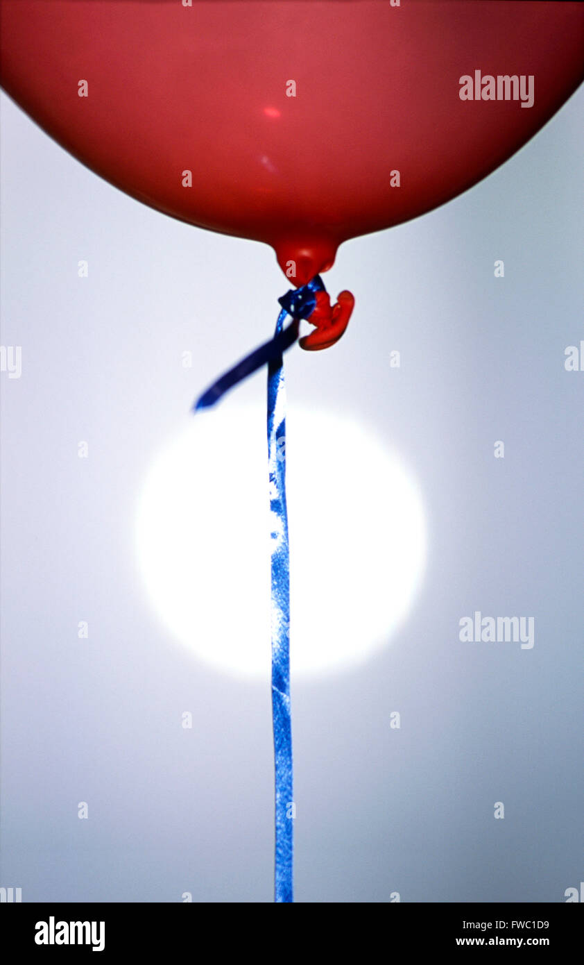 Red Ballon on a blue ribbon Stock Photo - Alamy