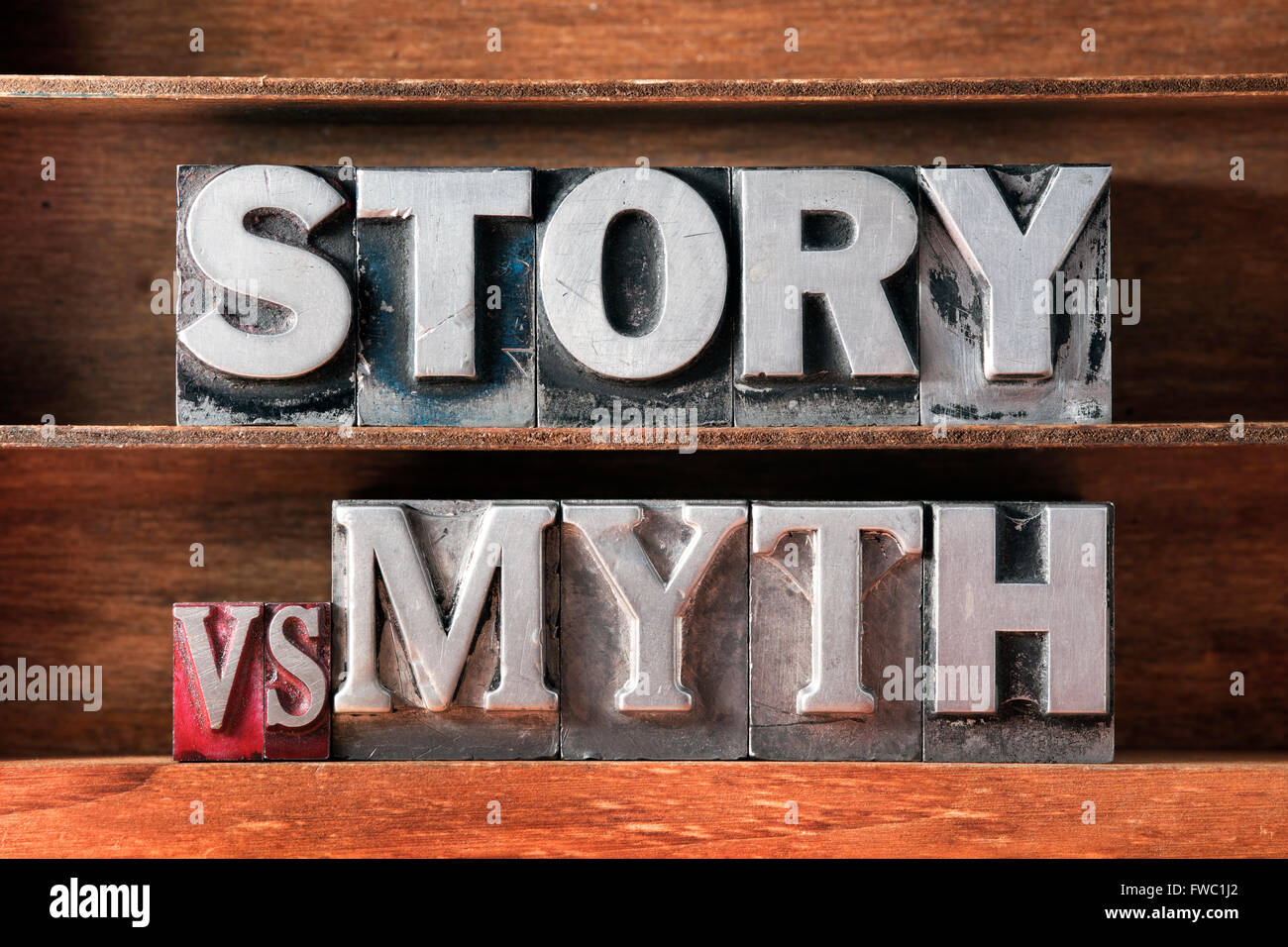 story vs myth phrase made from metallic letterpress type on wooden tray ...